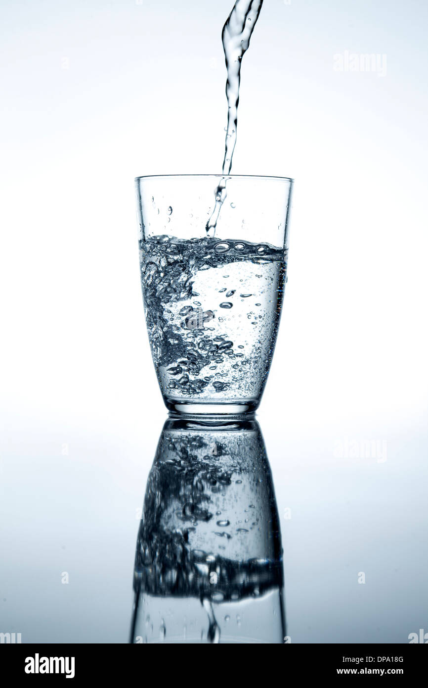 moment in which it pours pure sparkling water in a glass Stock Photo - Alamy