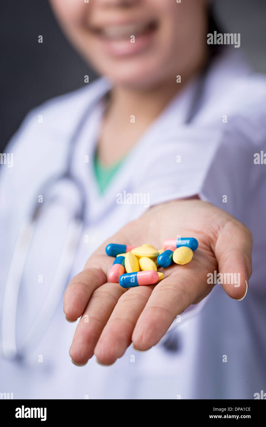 Asian female doctor shooting in studio Stock Photo - Alamy
