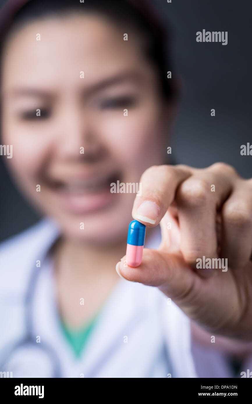 Asian female doctor shooting in studio Stock Photo - Alamy