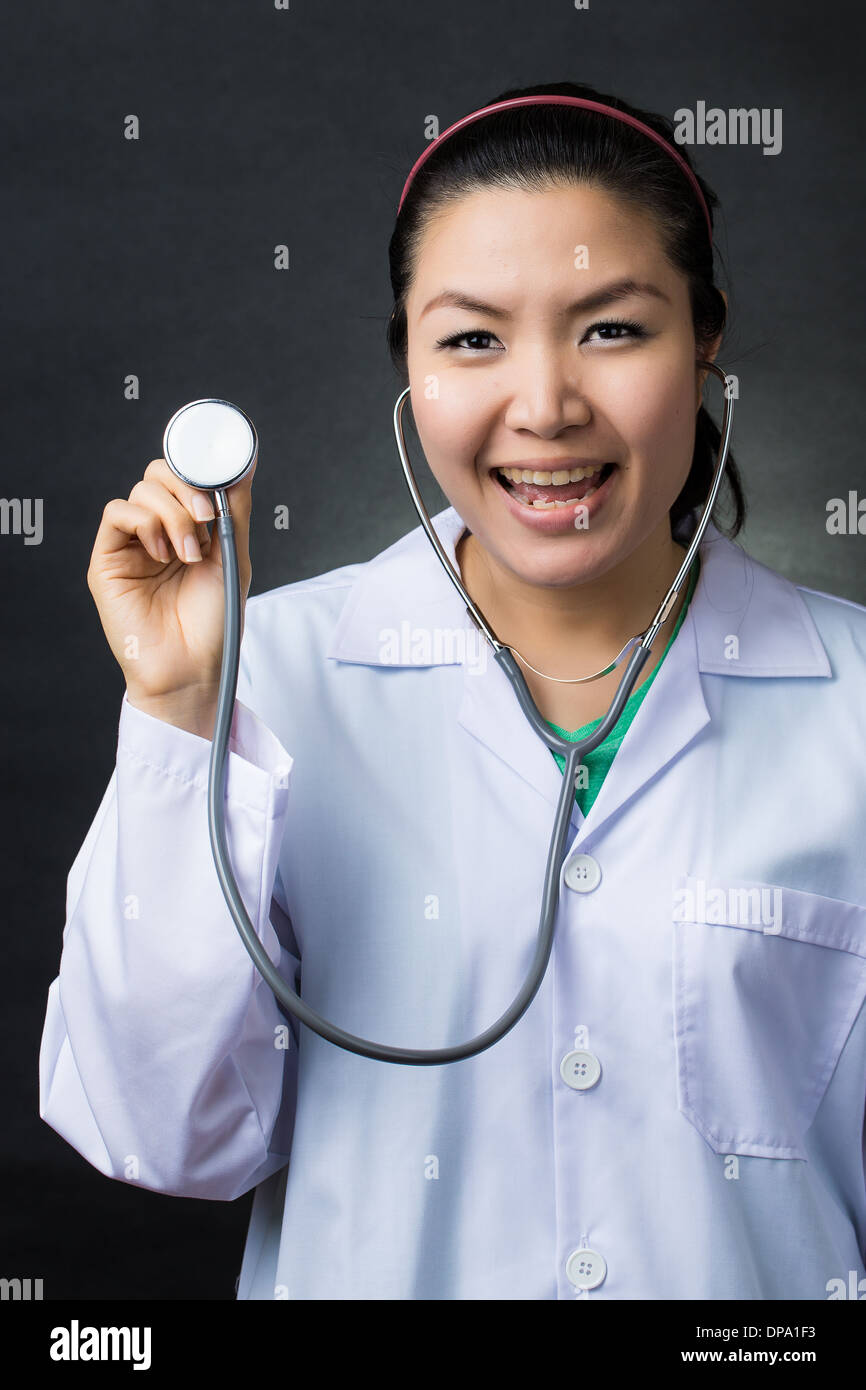 Asian female doctor shooting in studio Stock Photo - Alamy