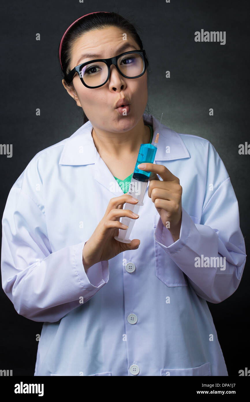 Asian female doctor shooting in studio Stock Photo - Alamy
