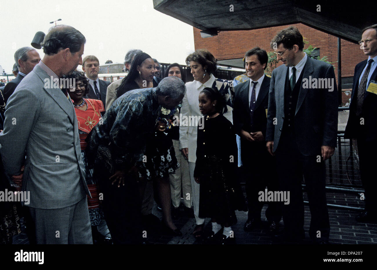 President Nelson Mandela speaking to a little girl with Charles, Prince ...