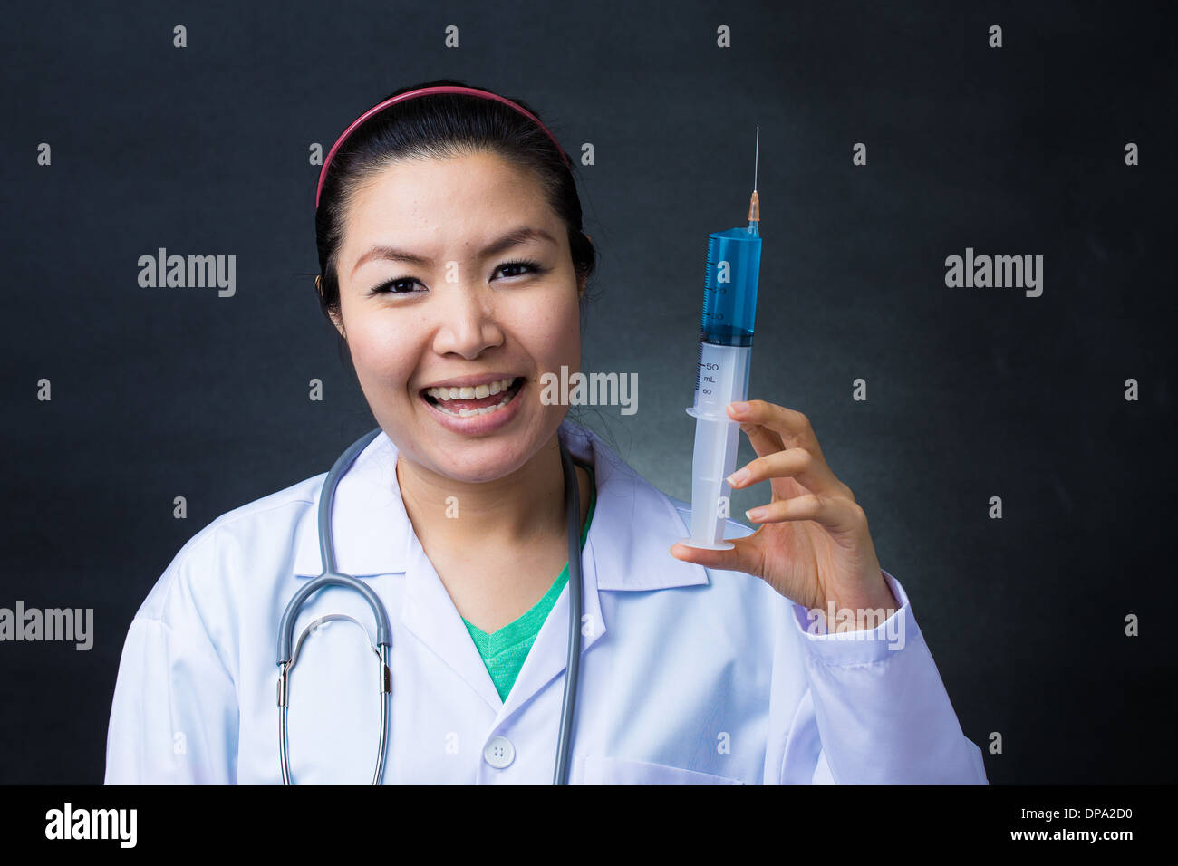 Asian female doctor shooting in studio Stock Photo - Alamy