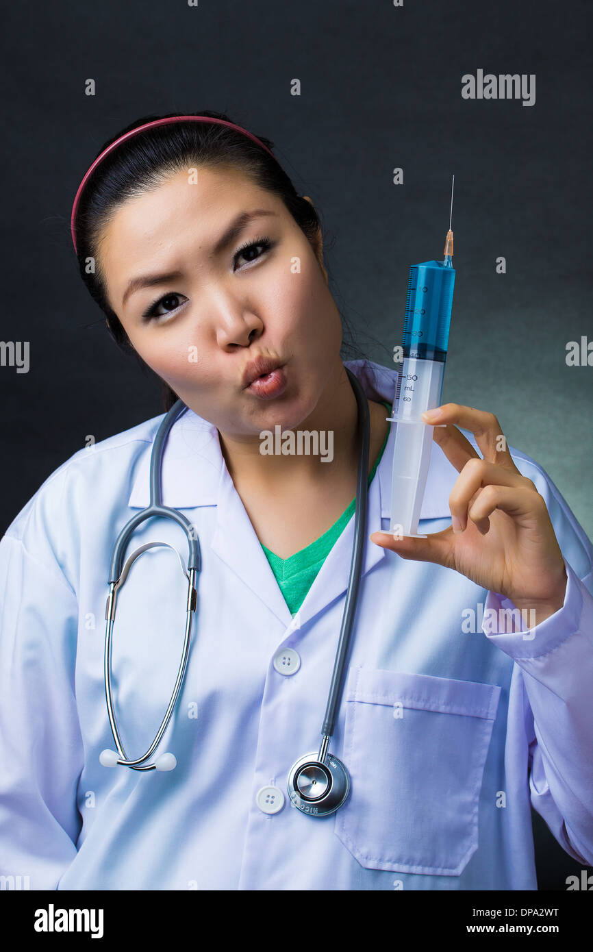 Asian female doctor shooting in studio Stock Photo - Alamy