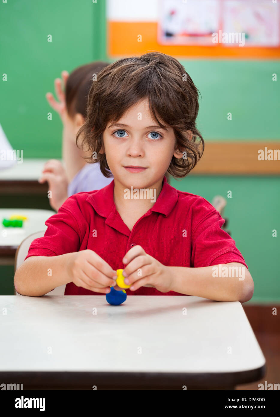 Boy Holding Clay Model At Desk Stock Photo - Alamy