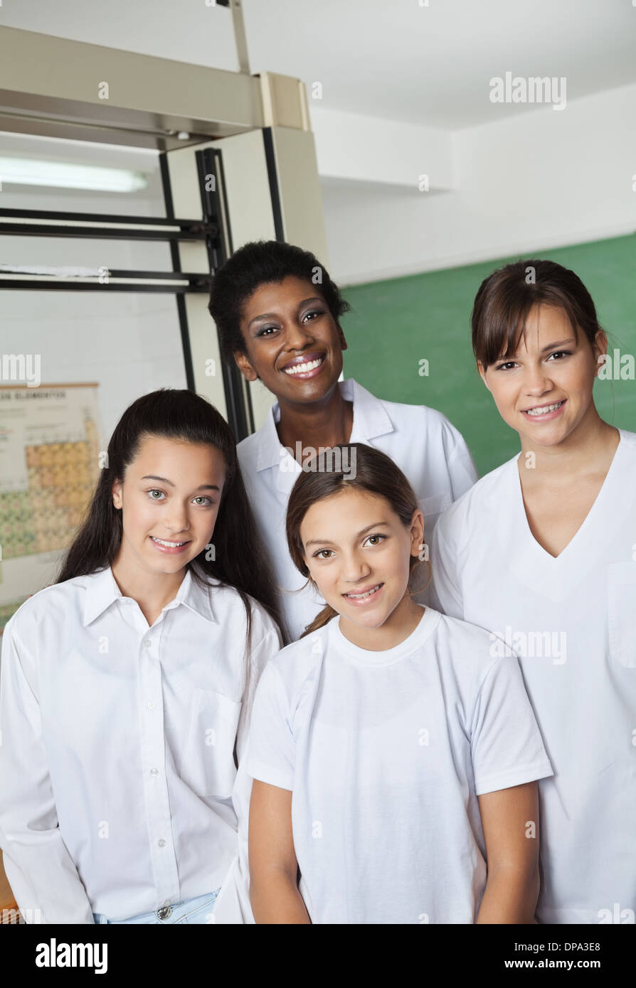 Teacher Standing With Female Students Stock Photo - Alamy