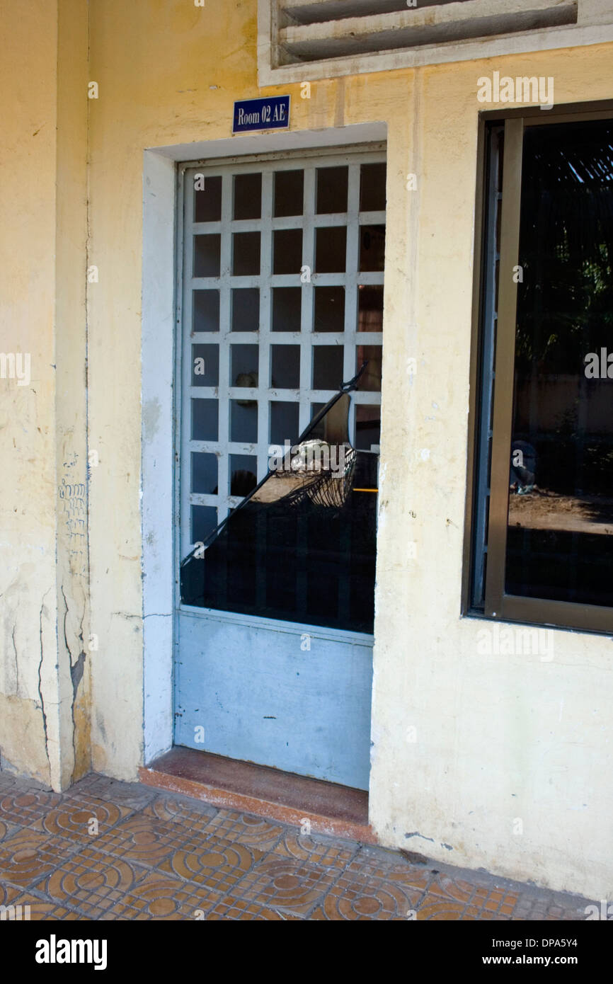 A dilapidated classroom with a broken door window stands vacant at the ...
