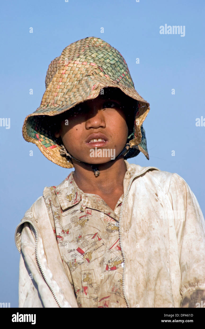 A young child laborer girl is working as a scavenger at the toxic and ...