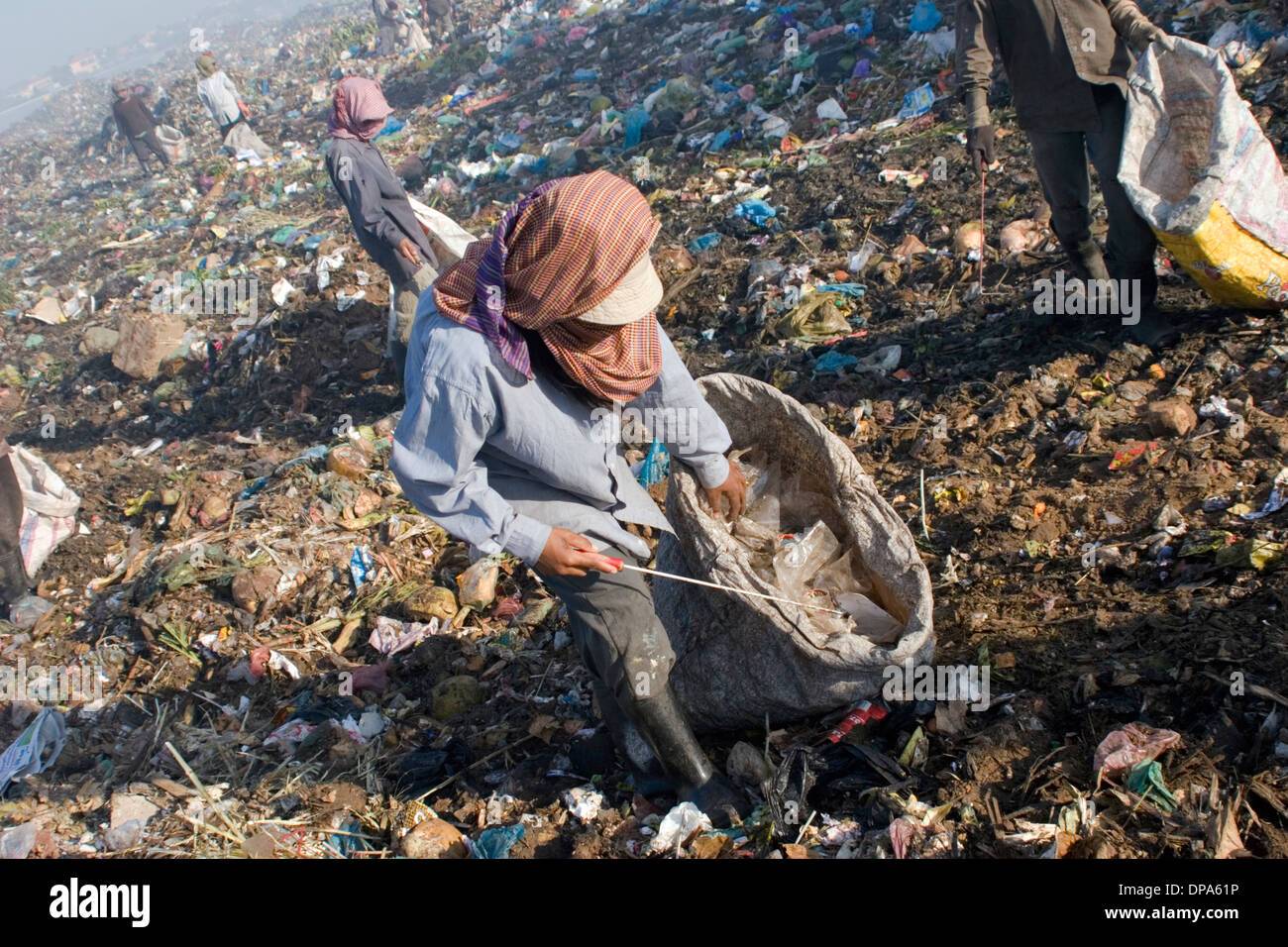 A man who is a scavenger is collecting recyclable plastic at the toxic ...
