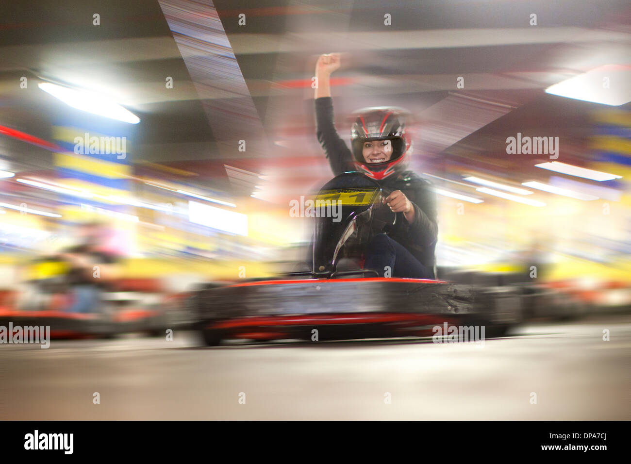 Mid adult woman driving go cart Stock Photo - Alamy