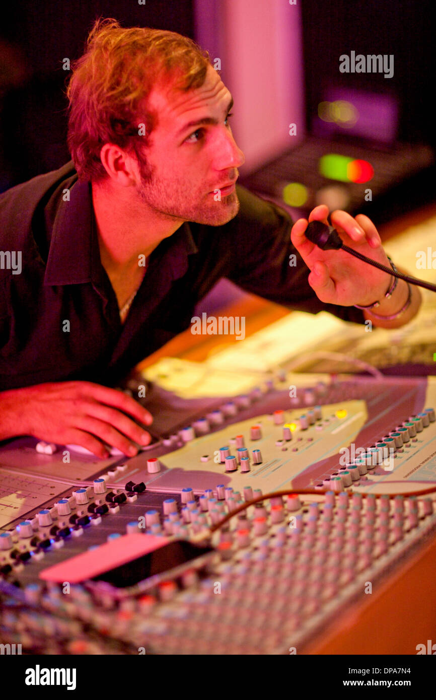 Young man on mixing desk Stock Photo - Alamy