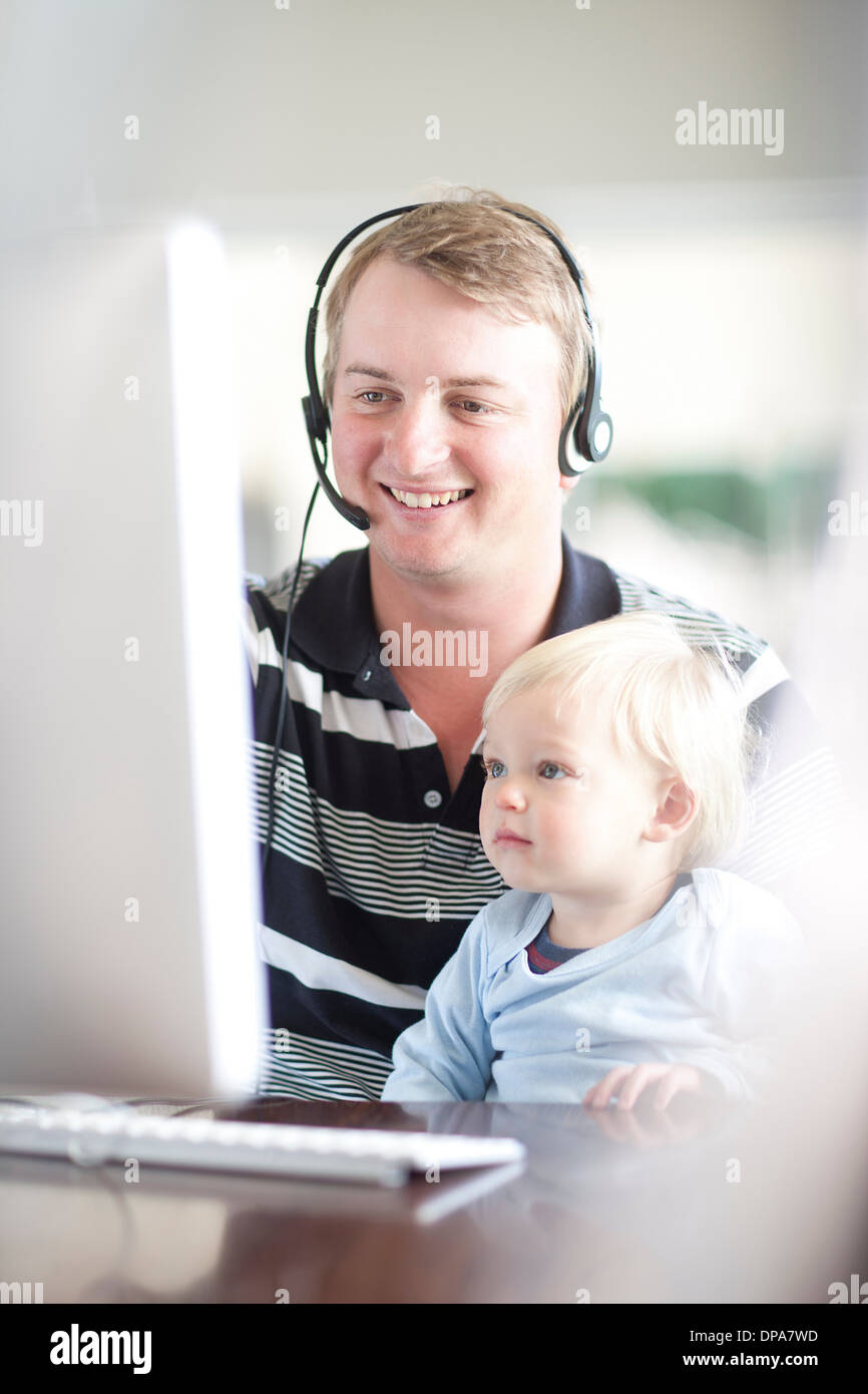 Father with baby boy using computer Stock Photo - Alamy