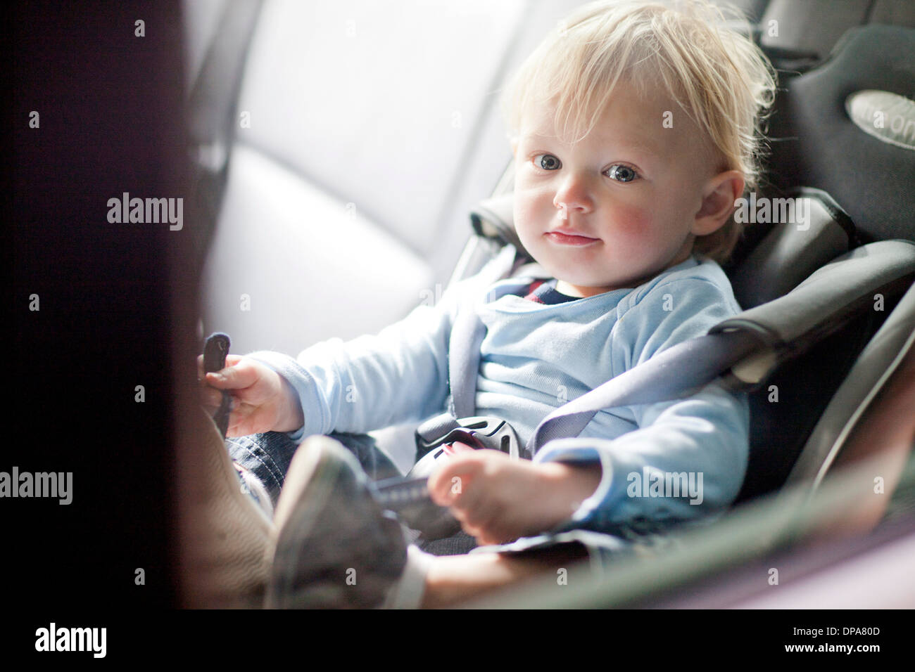 Baby boy in back seat of car Stock Photo - Alamy