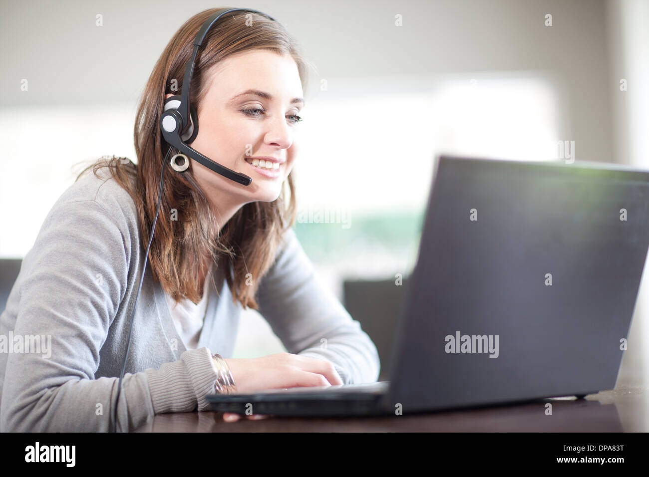 Young woman talking wearing headset hi-res stock photography and images ...