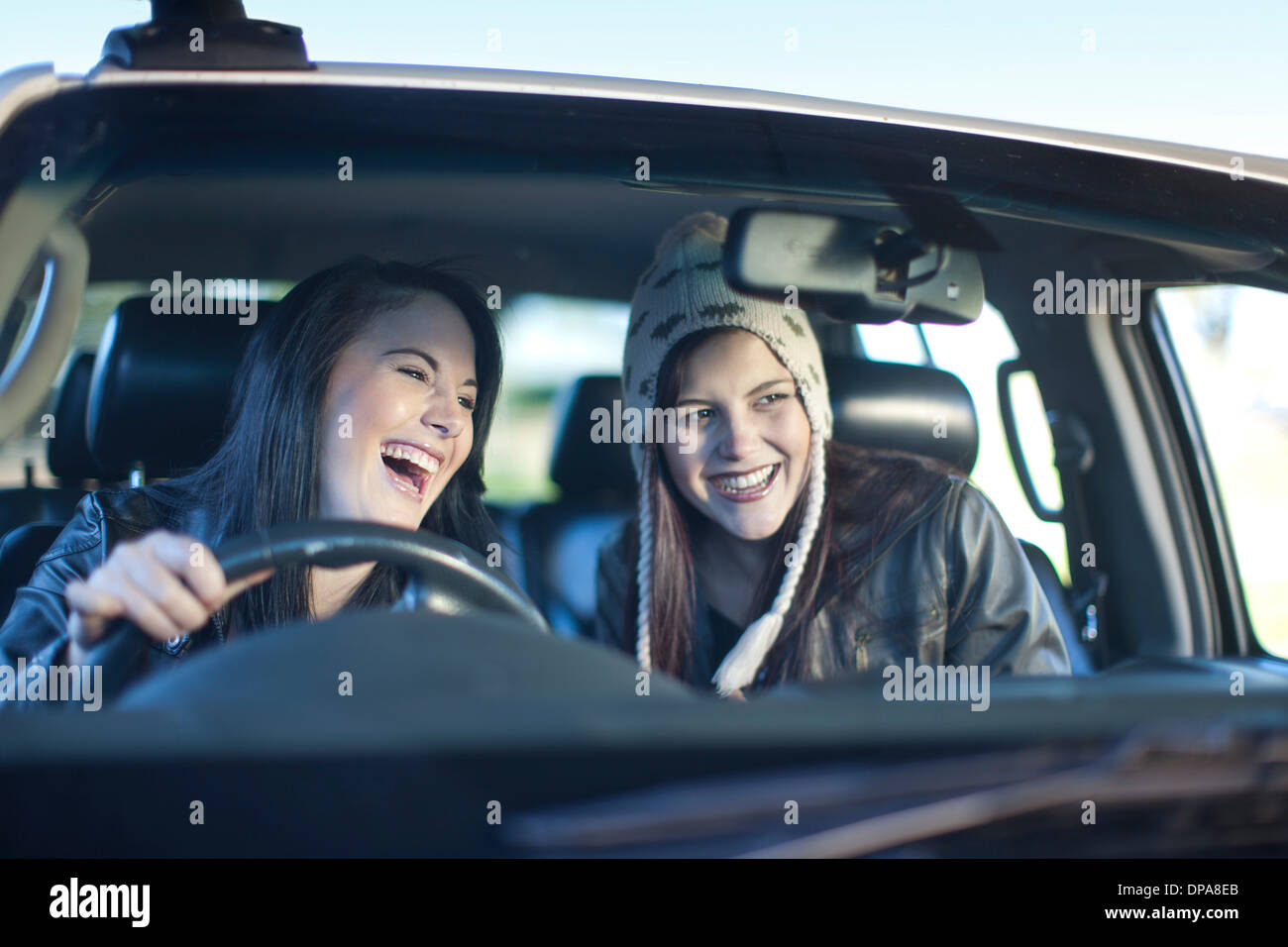 Two young women driving car Stock Photo - Alamy