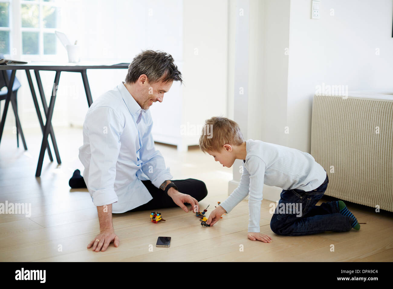 Father and son playing with toys Stock Photo - Alamy