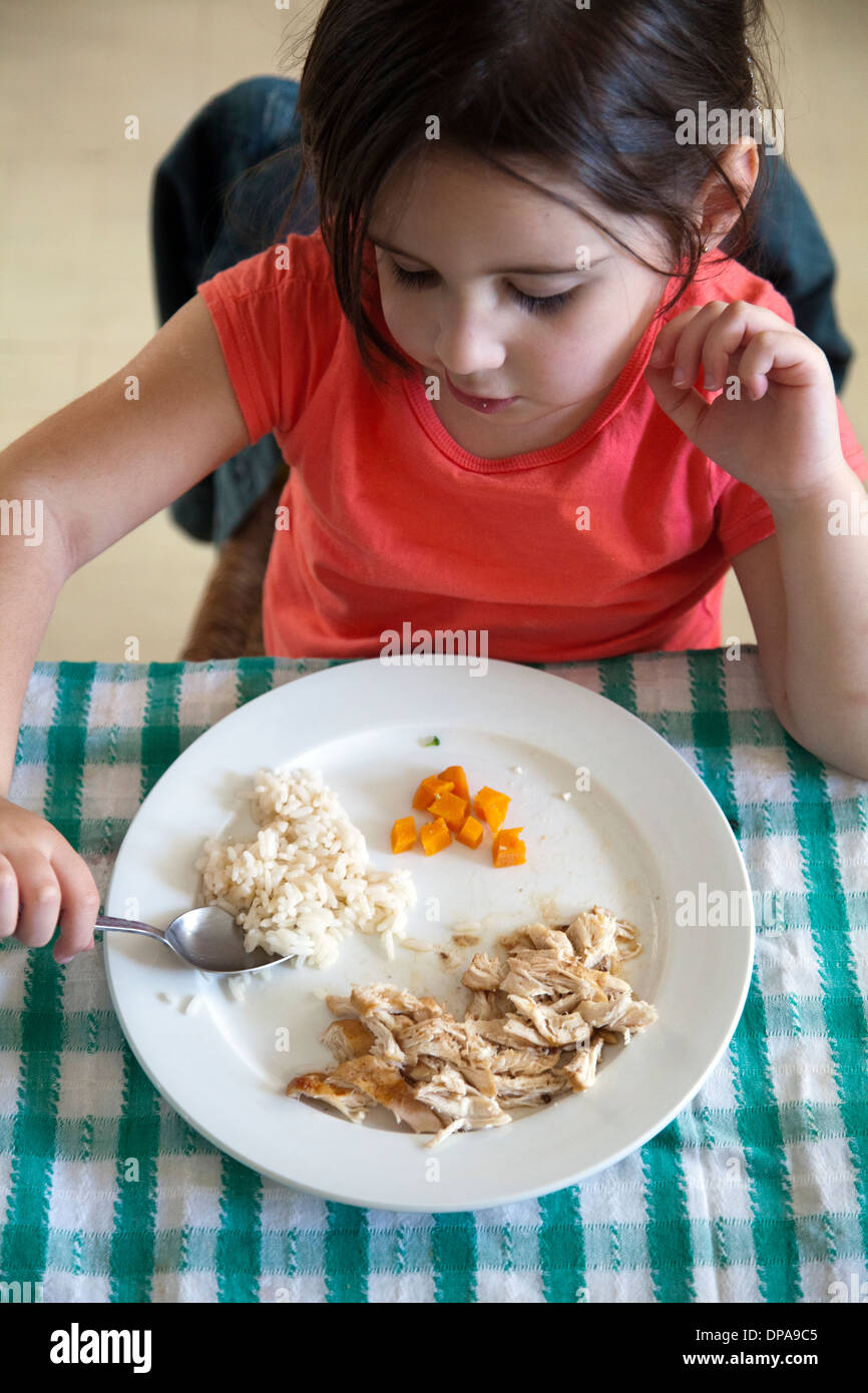 Young Girl Eating Dinner at Table Stock Photo - Alamy