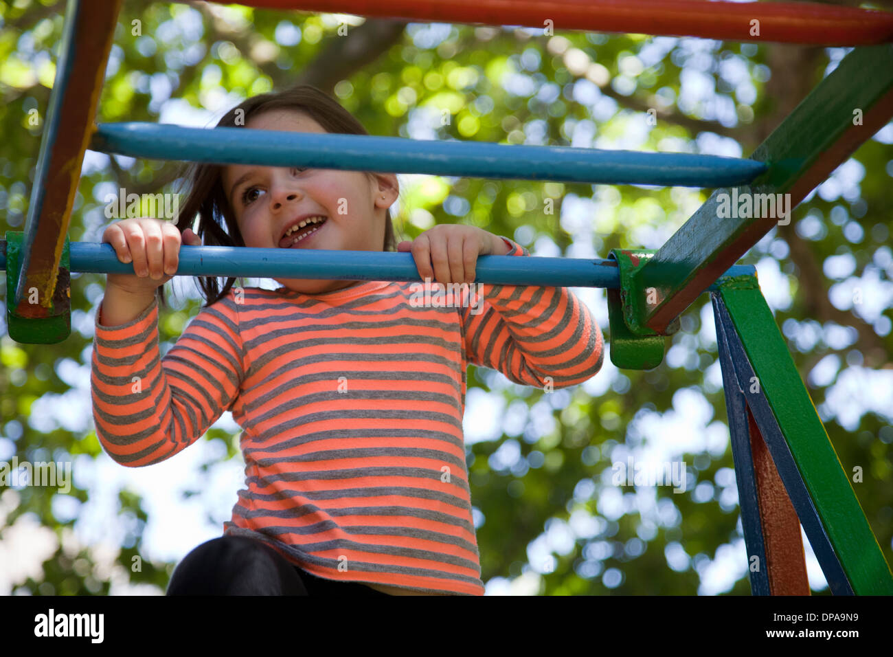 Girl on Playground Monkey Bars Stock Photo - Alamy
