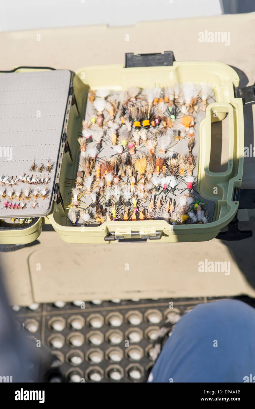 Man tying flies in a boat on a fly fishing trip Stock Photo - Alamy