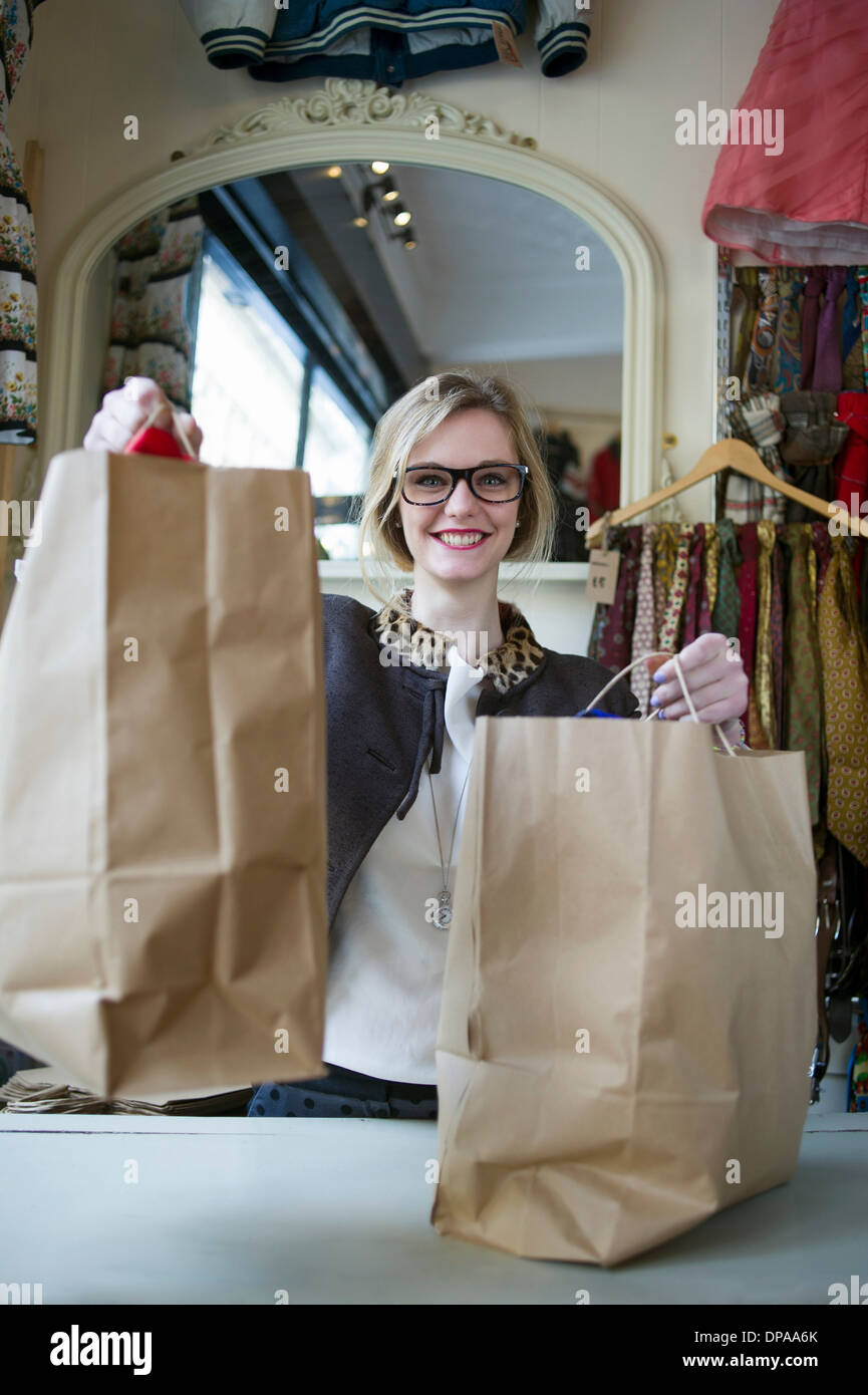 Woman holding bags of shopping Stock Photo - Alamy