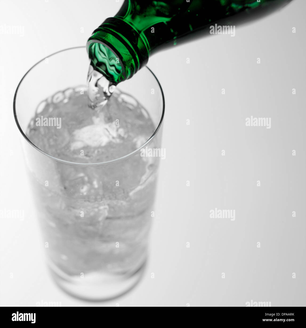 Pouring sparkling water into glass Stock Photo - Alamy