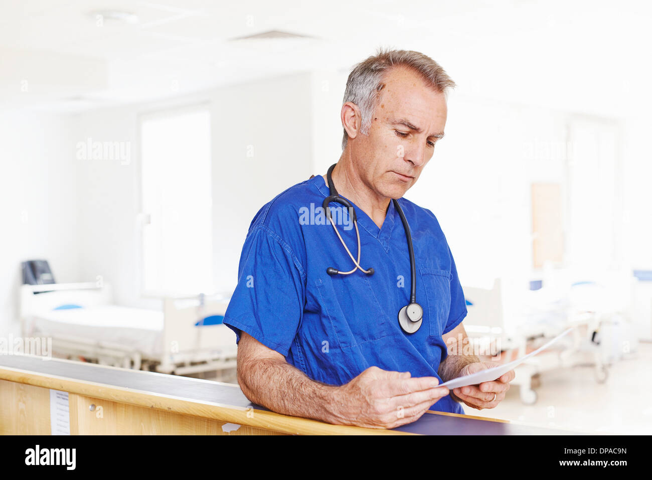 Doctor reading notes Stock Photo - Alamy