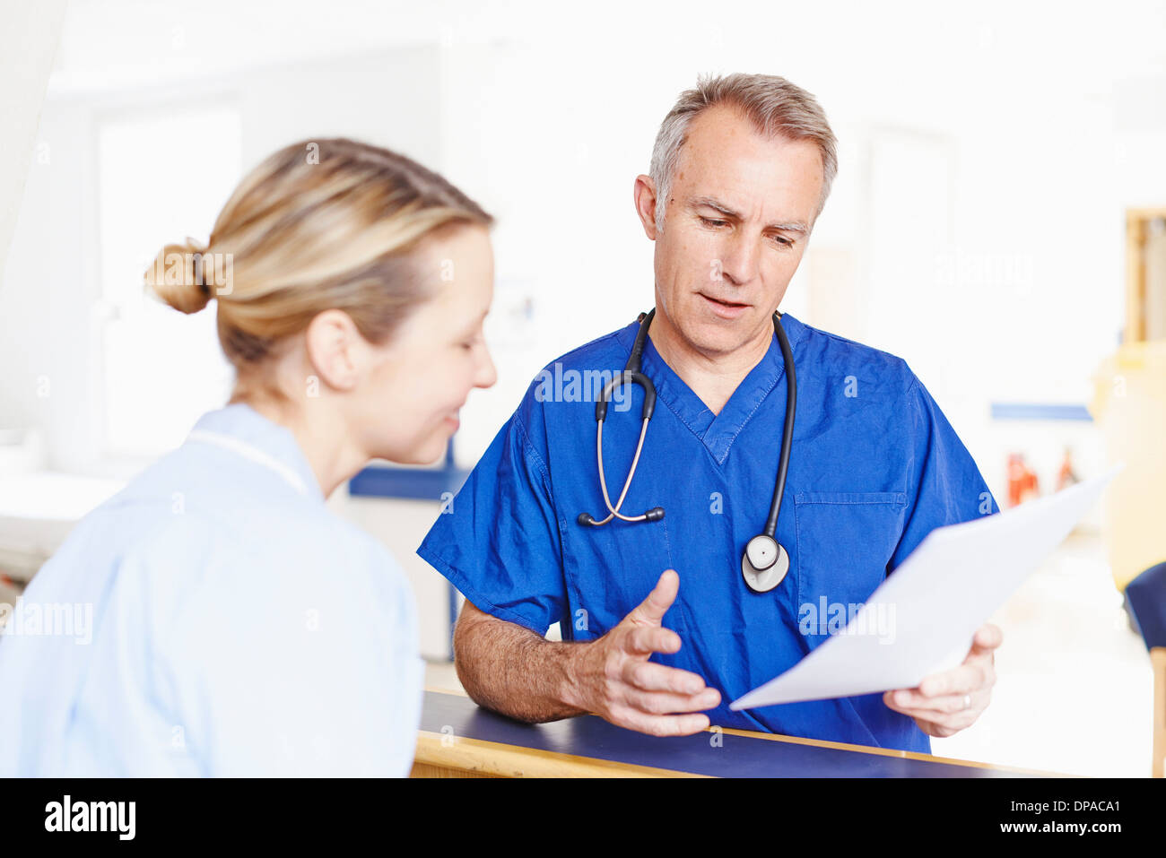 Doctor and nurse looking at notes Stock Photo - Alamy