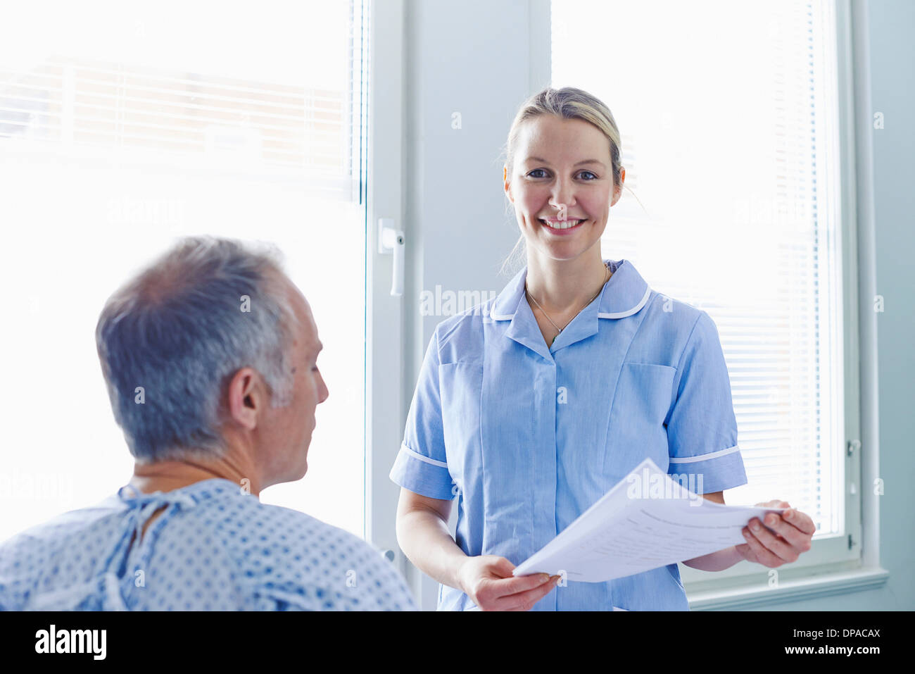 Nurse having conversation with patient Stock Photo - Alamy