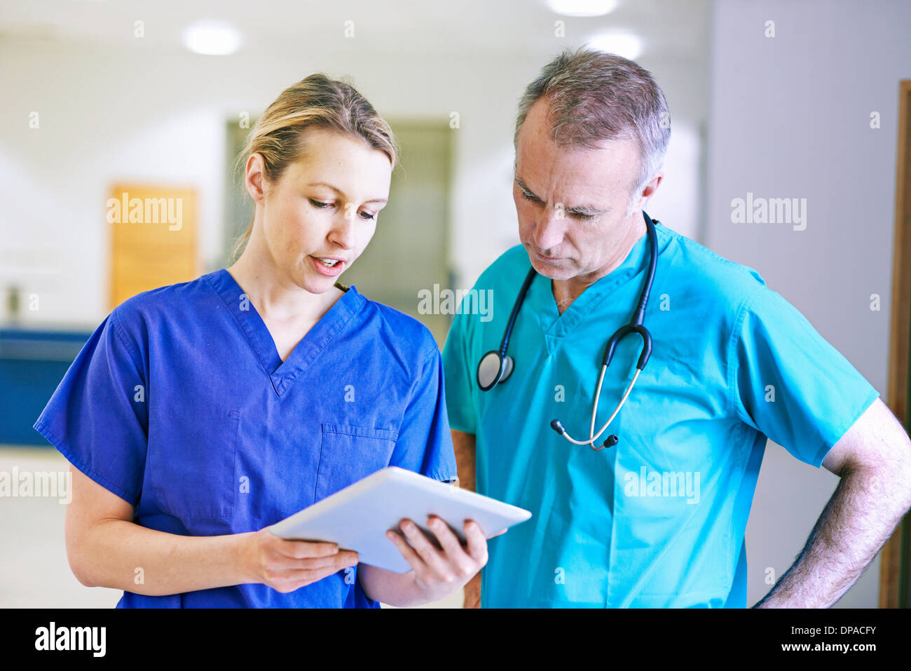 Doctor and surgeon looking at medical records Stock Photo - Alamy
