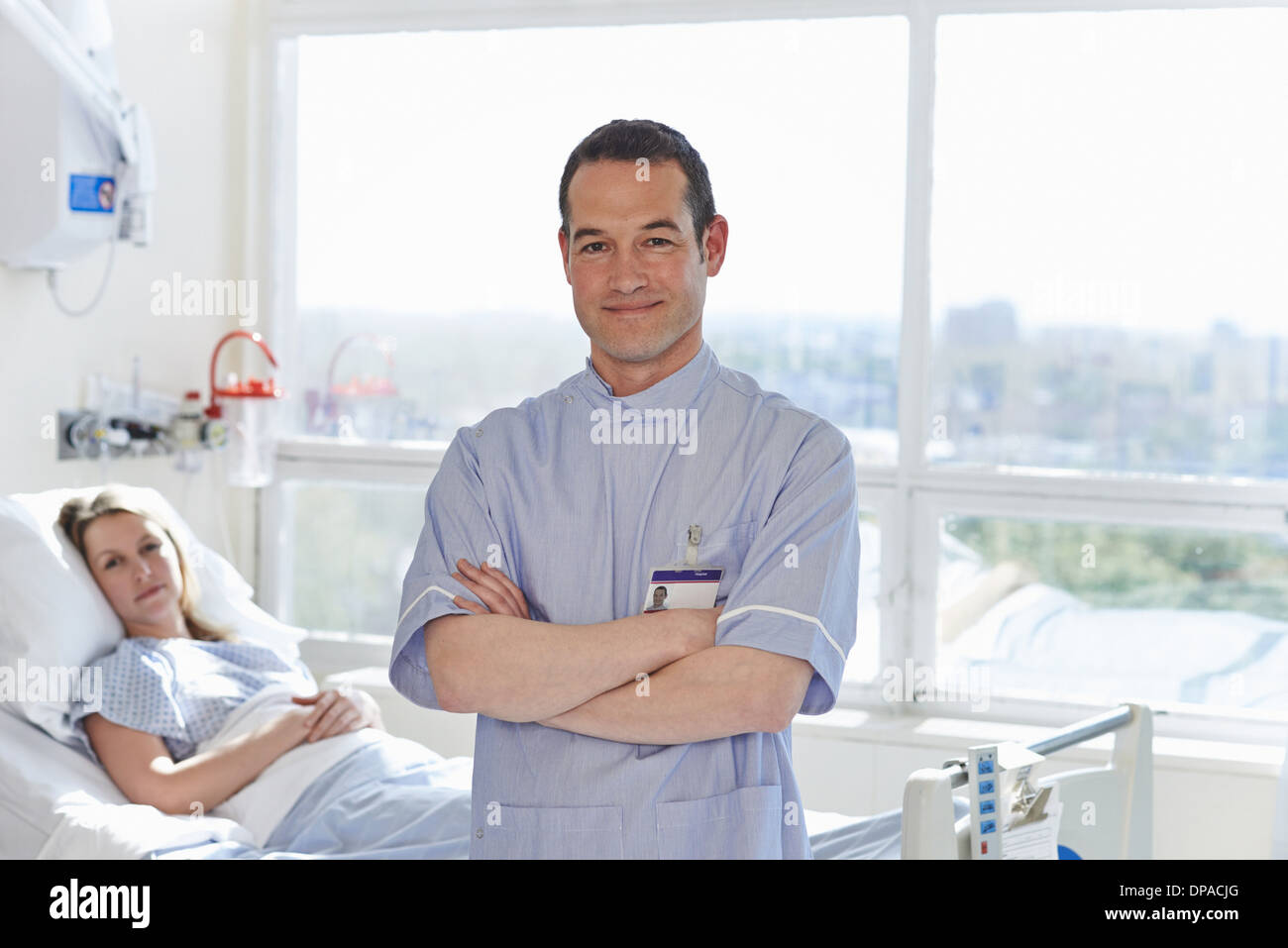 Portrait of nurse standing in front of patient Stock Photo - Alamy