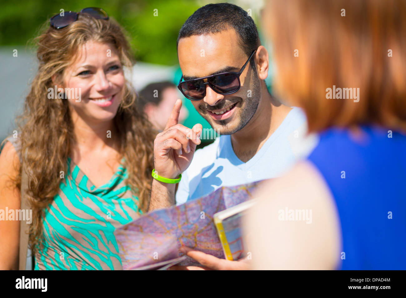 Tourists looking at map Stock Photo - Alamy