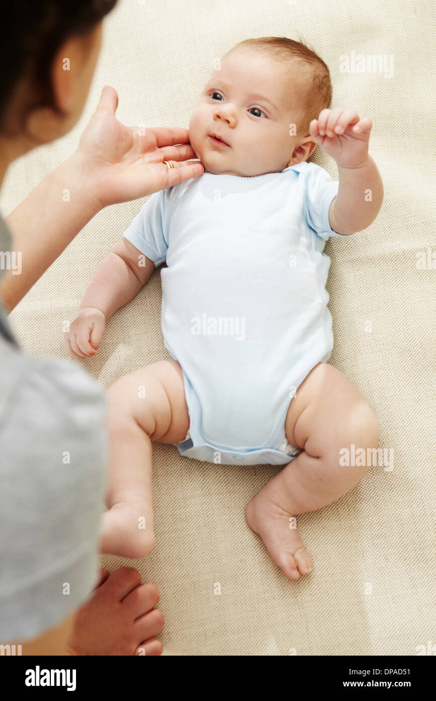 Hand touching baby cheek hi-res stock photography and images - Alamy