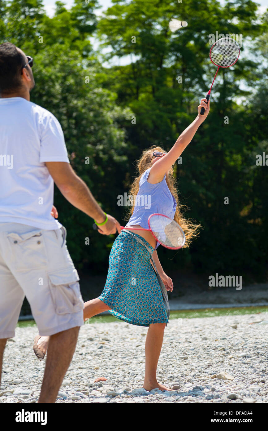 Mid adult couple playing badminton Stock Photo - Alamy