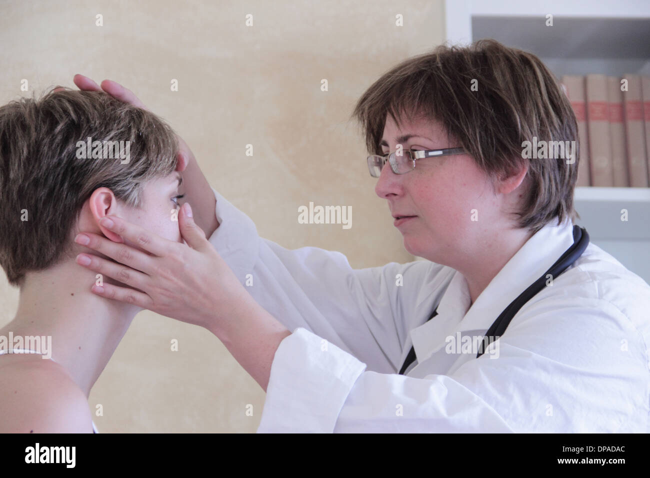 Doctor examining woman's face Stock Photo - Alamy