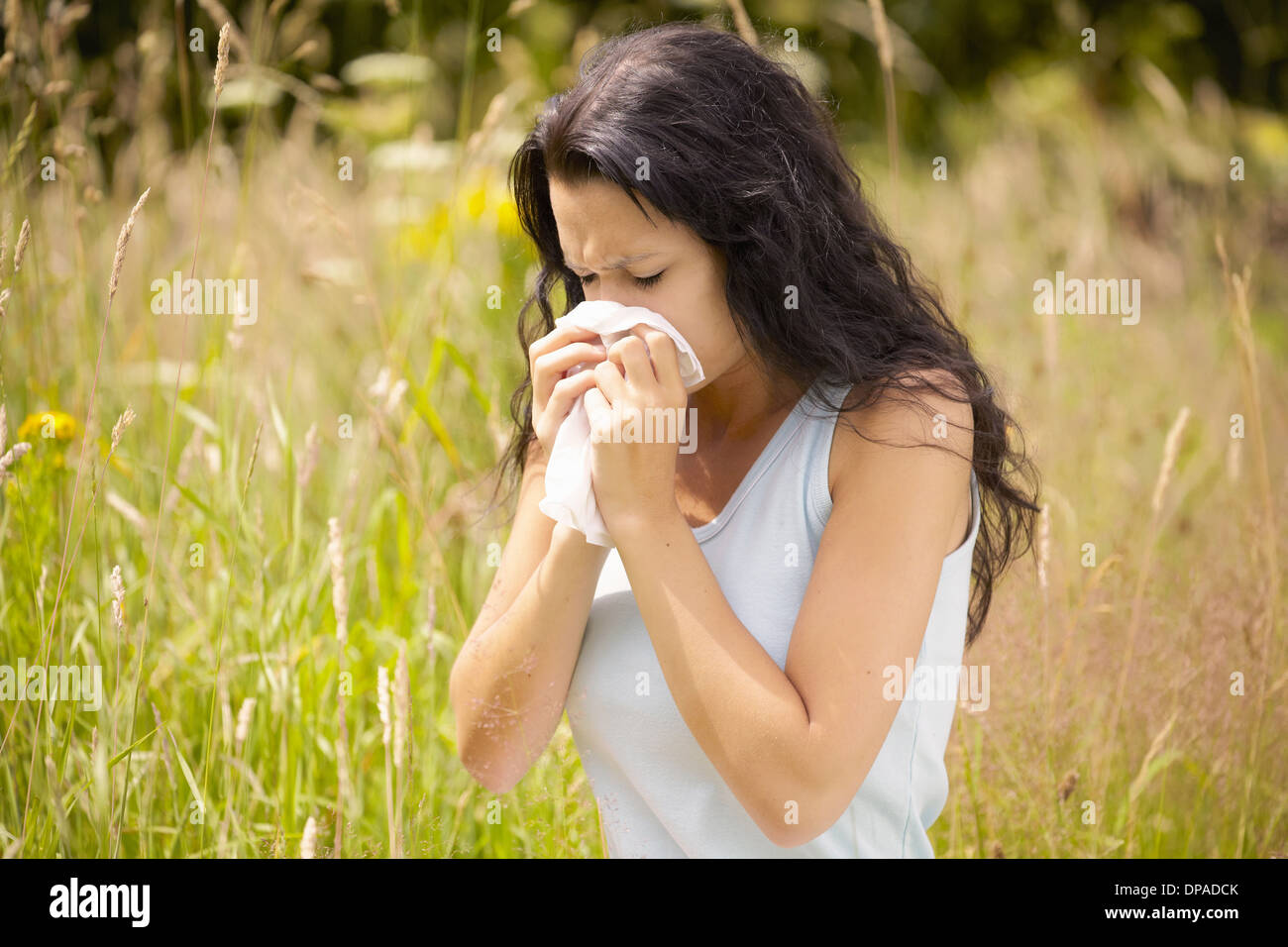 Girl wiping nose with tissue Stock Photo - Alamy