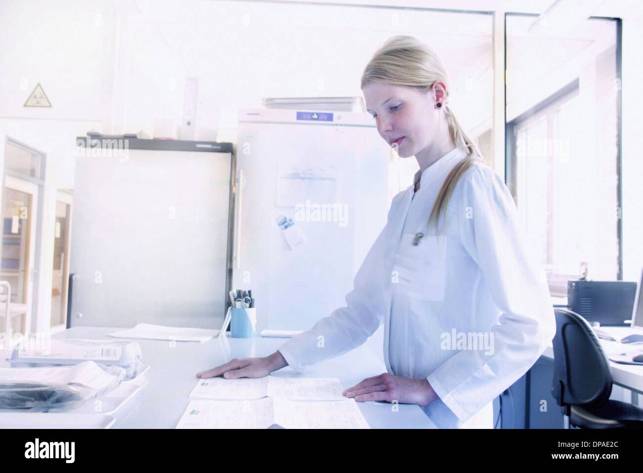 Scientist looking down at papers Stock Photo - Alamy