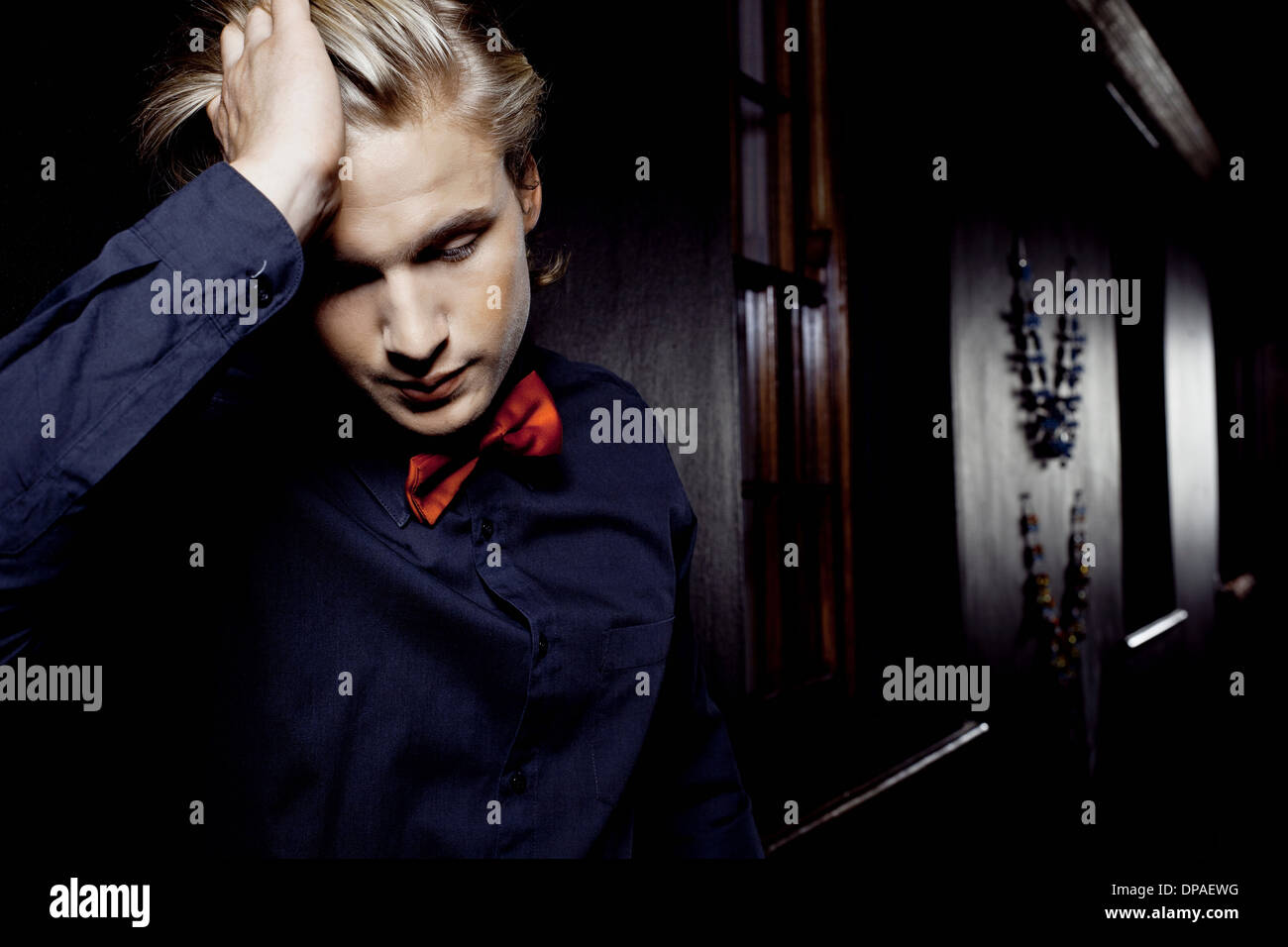 Young man alone in nightclub looking distressed Stock Photo - Alamy