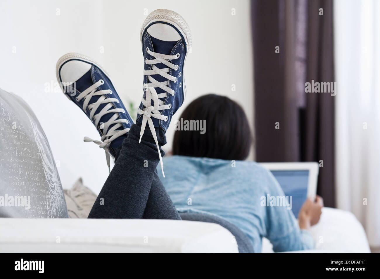 Woman lying on sofa digital hi-res stock photography and images - Alamy