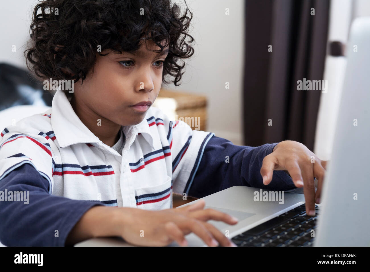 Boy using laptop Stock Photo - Alamy