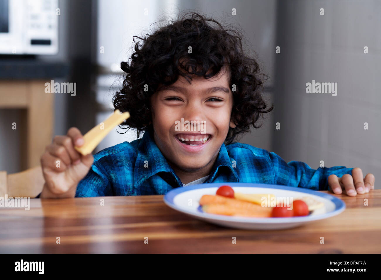Boy eating snacks Stock Photo - Alamy