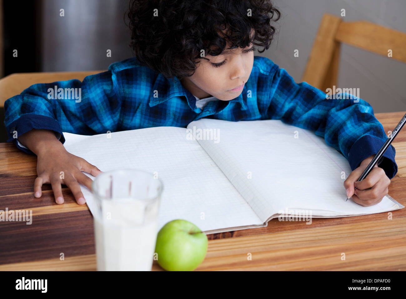 Boy doing homework Stock Photo - Alamy