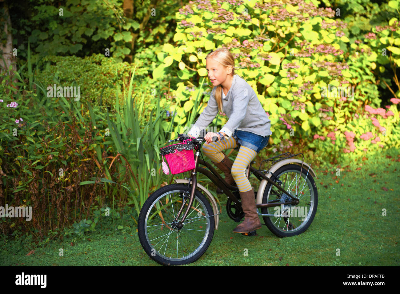 Girl riding bicycle hi-res stock photography and images - Alamy