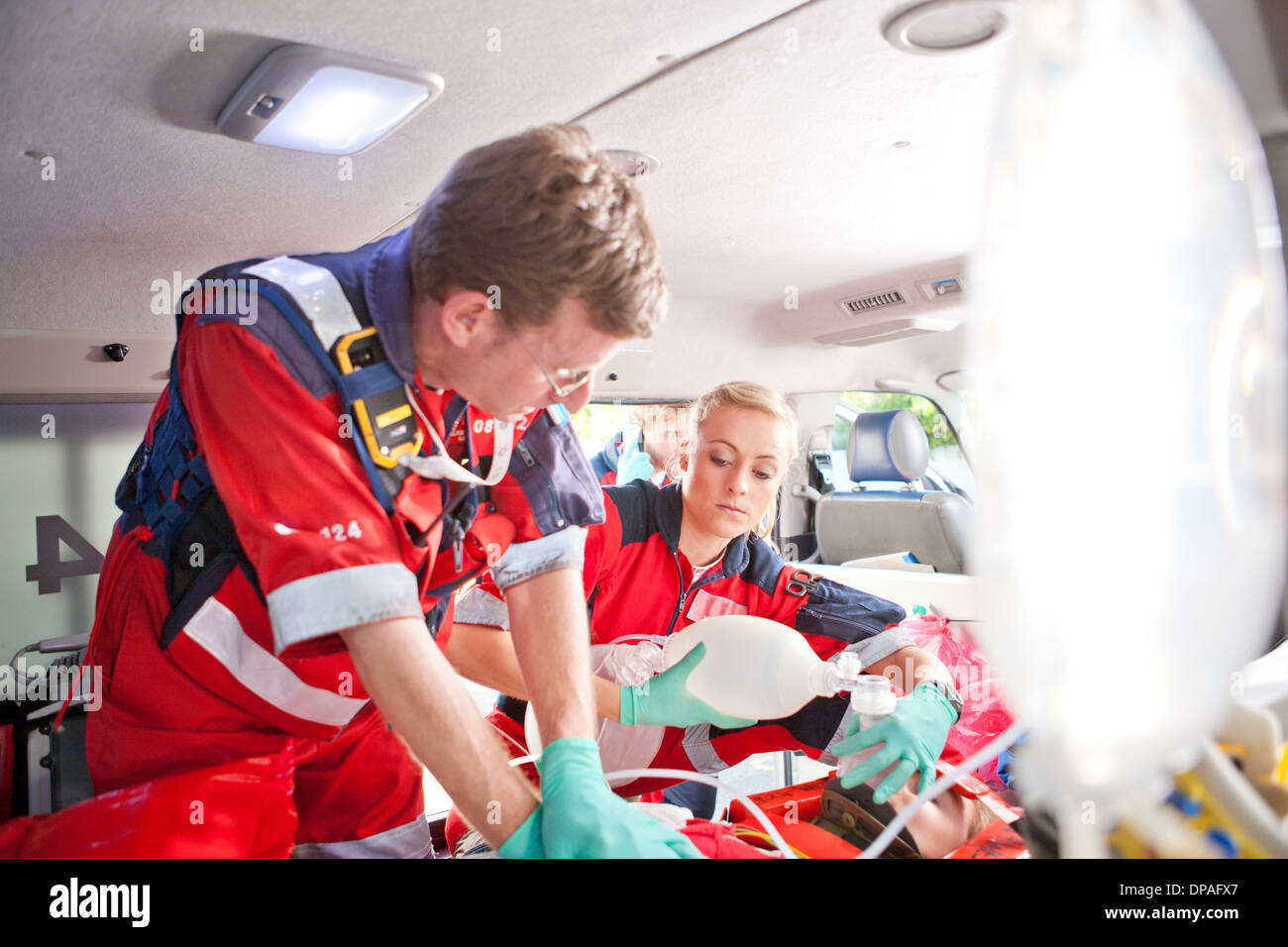 Paramedics giving patient heart massage in ambulance Stock Photo - Alamy