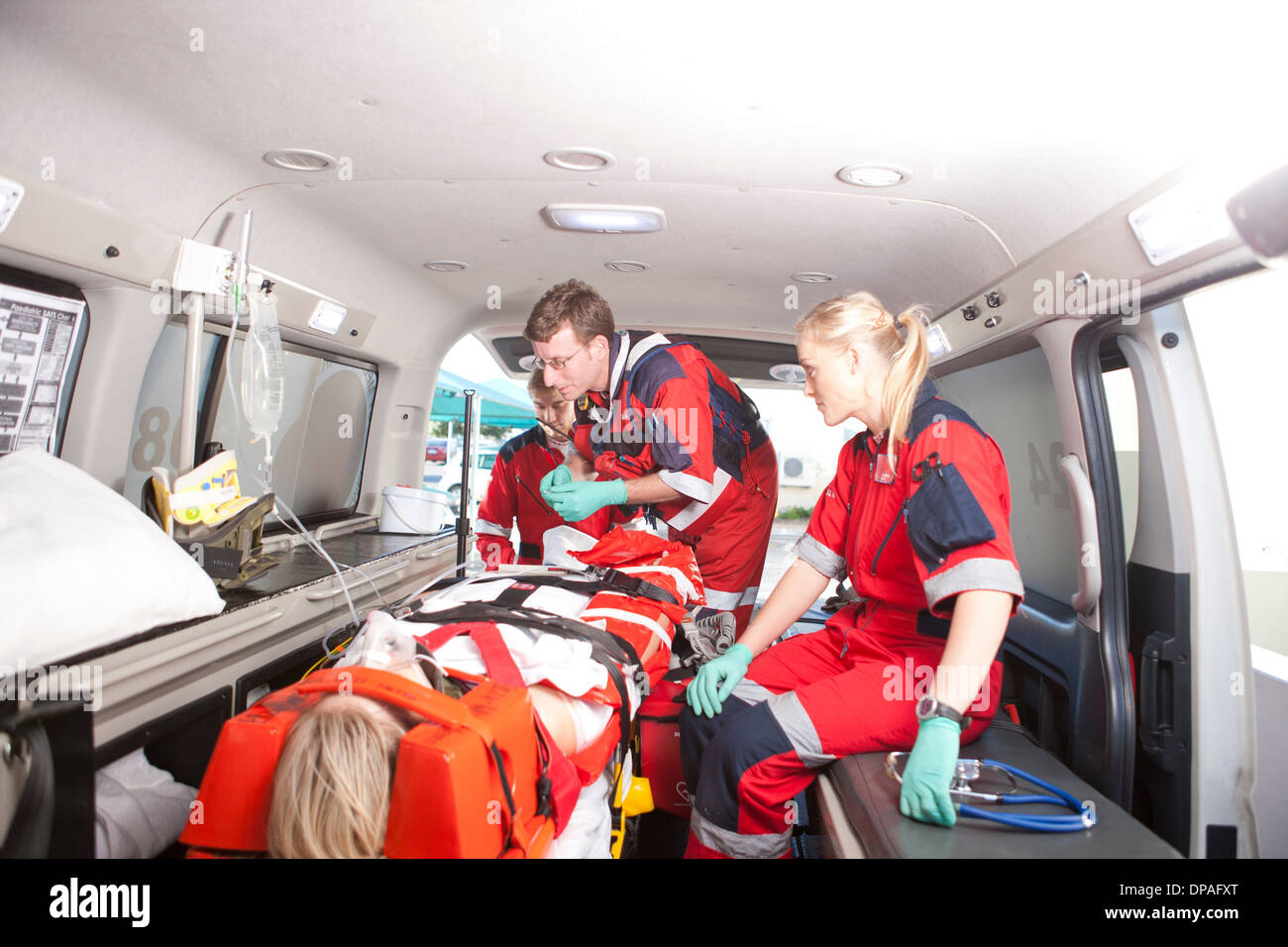 Paramedics in ambulance working with patient Stock Photo - Alamy