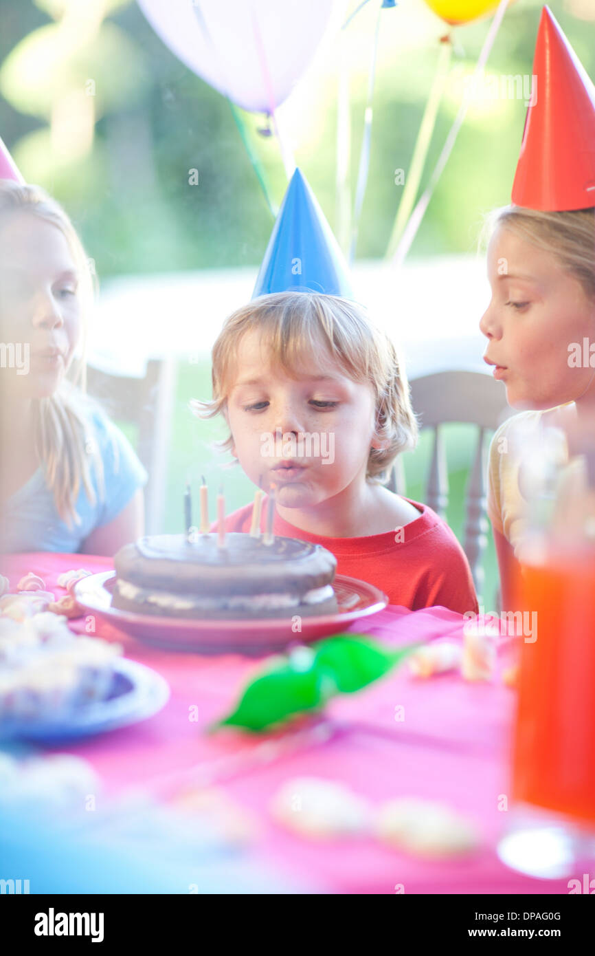 Brother and his sisters enjoying birthday party Stock Photo - Alamy
