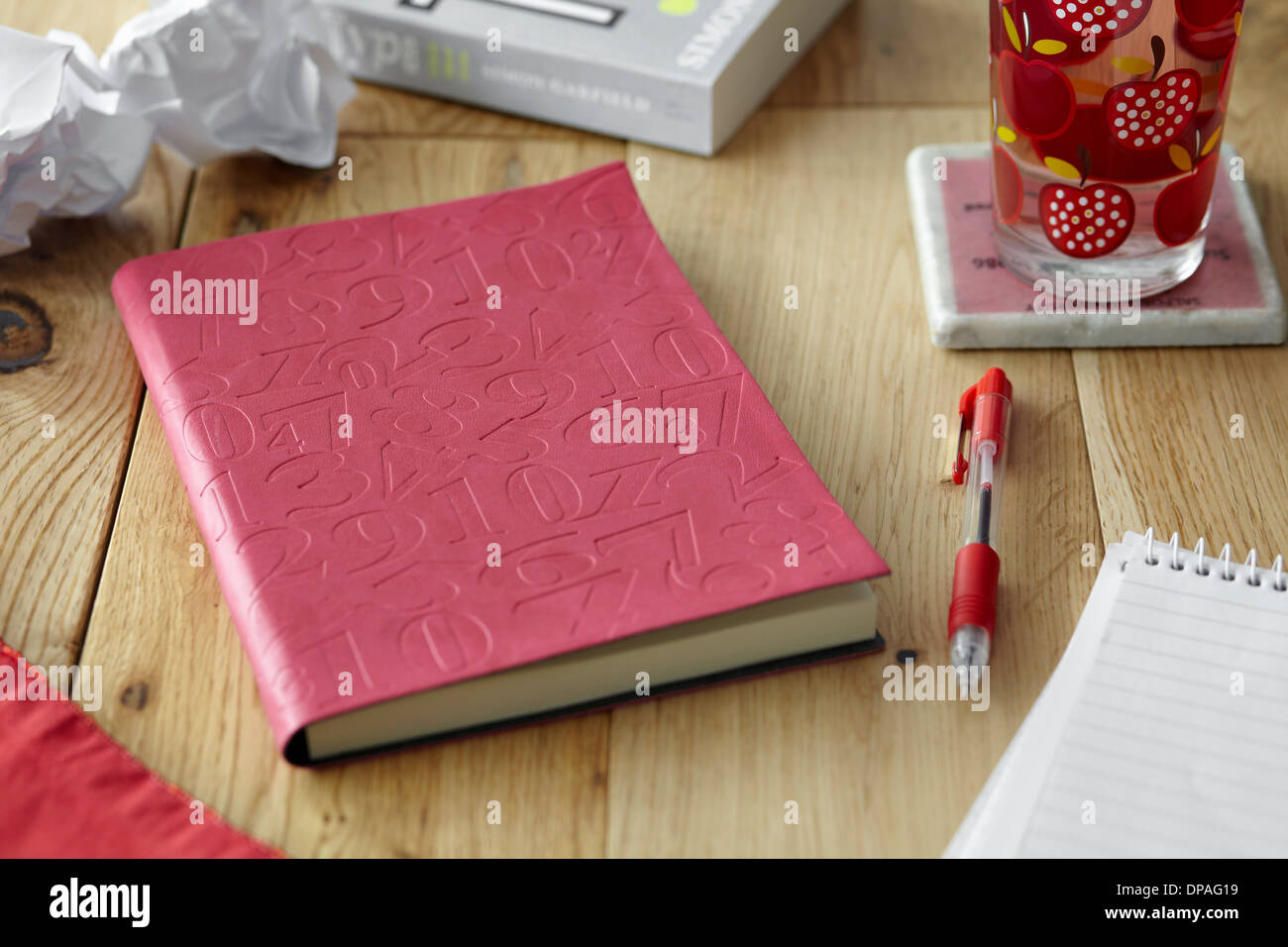 Kitchen table still life with books, pen and crumpled paper Stock Photo ...