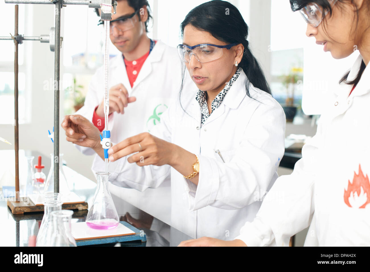 Chemistry teacher doing experiment with students Stock Photo - Alamy