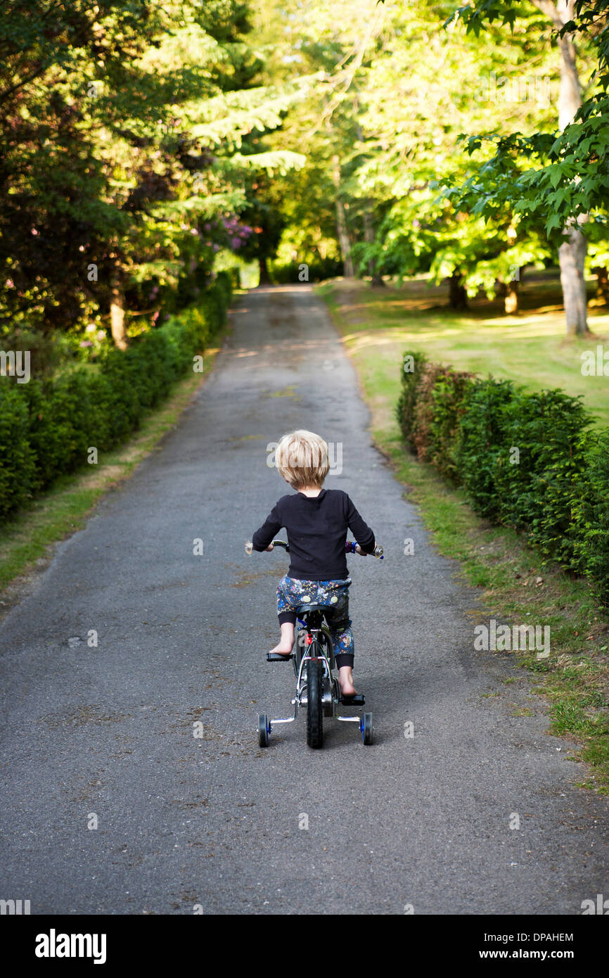 Boy riding tricycle on path hi-res stock photography and images - Alamy