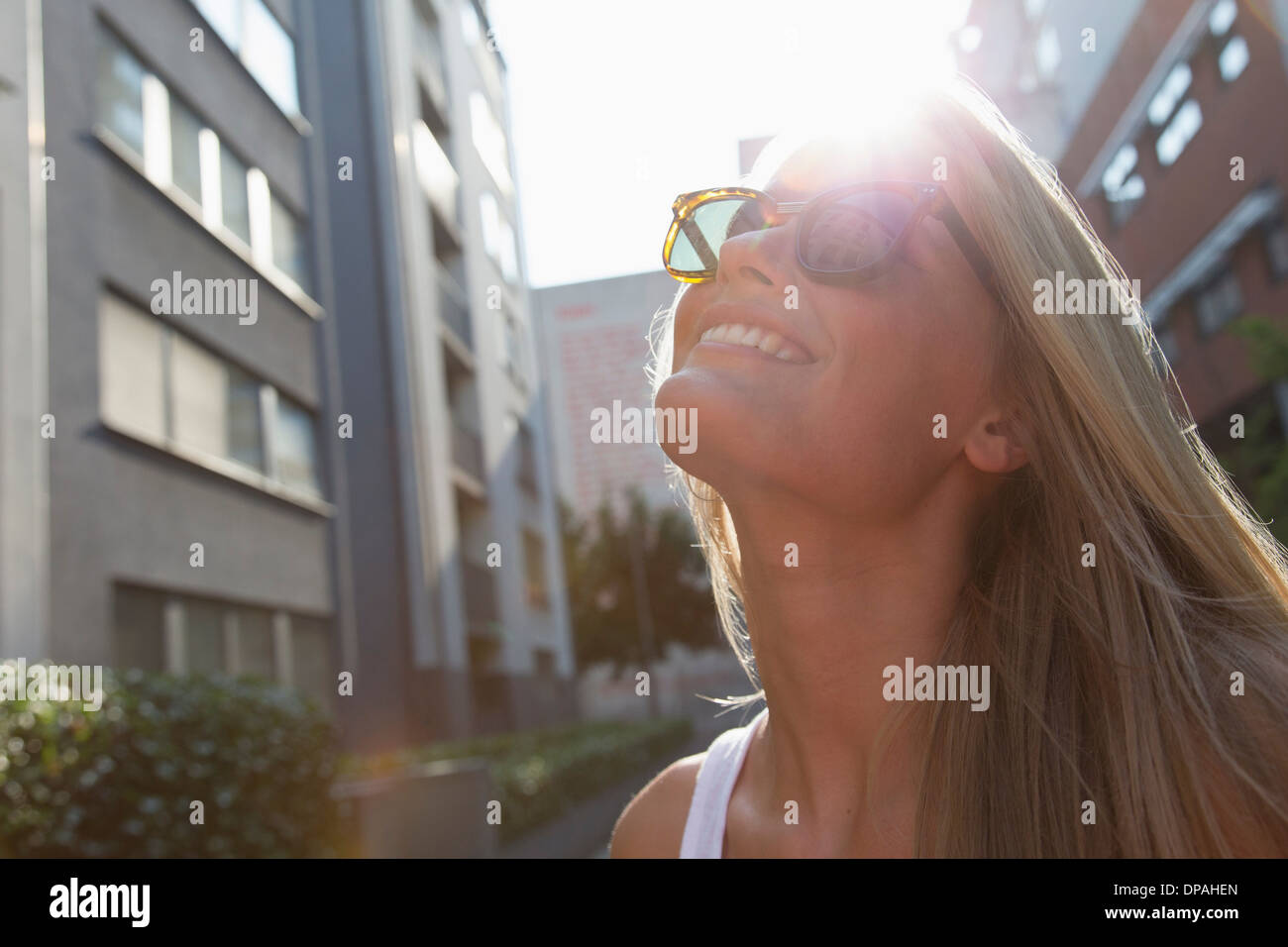 Young woman looking up Stock Photo - Alamy