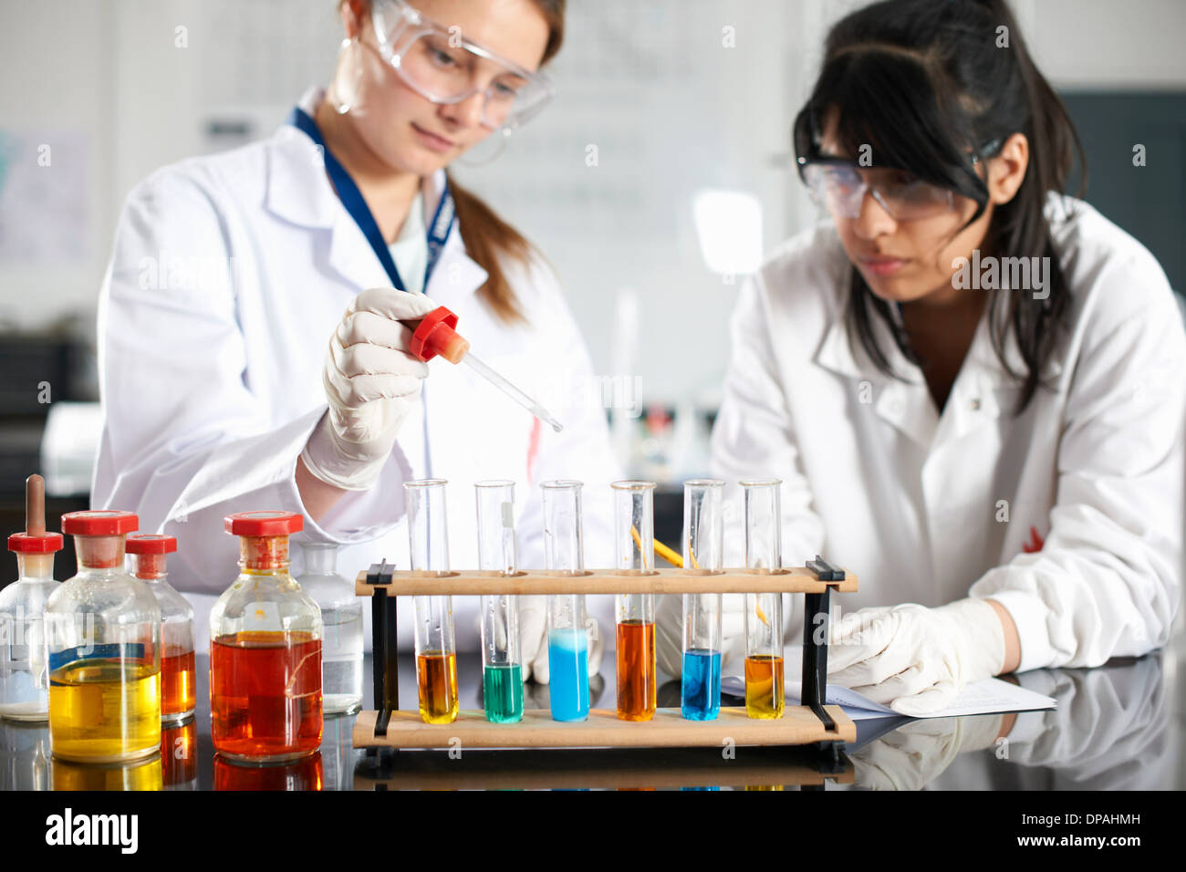 Two chemistry students doing experiment Stock Photo - Alamy